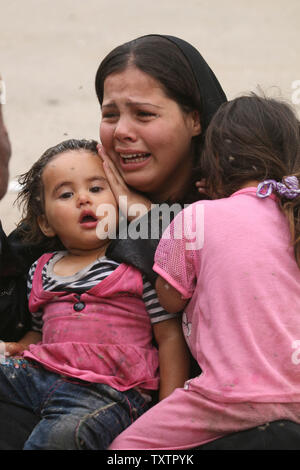 BAGHDAD, Iraq - People cry on the outskirts of Baghdad on April 26 ...
