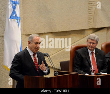 Prime Minister Stephen Harper listens as French President Nicolas ...