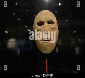 A mask from the Neolithic period ( 9,000 years ago) is displayed in the ...