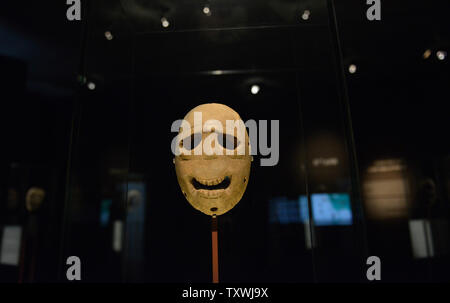 A mask from the Neolithic period ( 9,000 years ago) is displayed in the ...