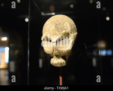 A mask from the Neolithic period ( 9,000 years ago) is displayed in the ...