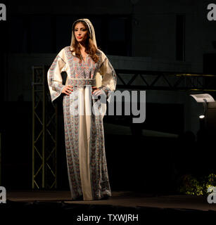 A Palestinian model wears a traditional dress by Palestinian designer ...