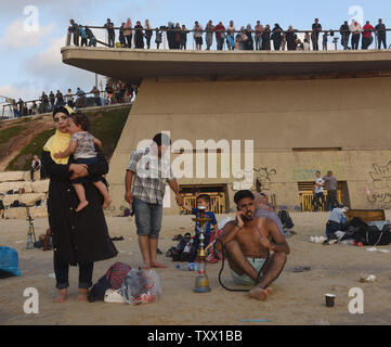 Palestinians enjoy the beach of the Mediterranean Sea during a heat ...