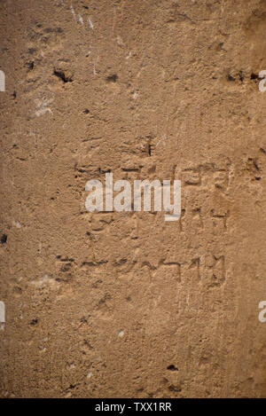 Close-up photo of an inscription written with white letters saying ...