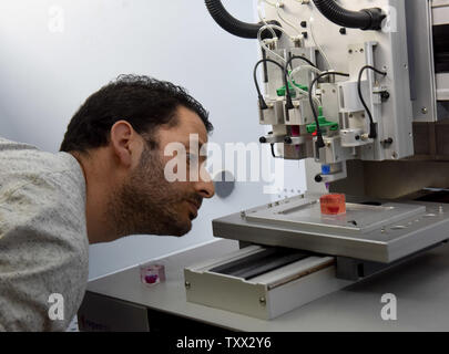 Israeli scientist Professor Tal Dvir, holds a 3D printed heart, in what ...