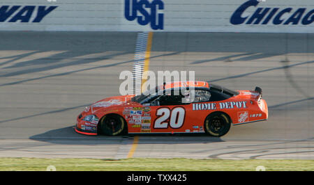Tony Stewart crosses the finish line to win the Allstate Brickyard 400 ...