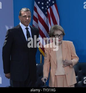 Former Walt Disney Company Chairman and CEO Robert Iger (left) gives ...