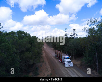 Aerial of a fully loaded Logging truck crossing causeway over the ...