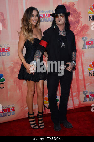 Musician Niki Sixx, right, and Courtney Bingham attend the iHeartRadio ...