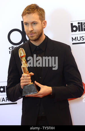 DJ Calvin Harris poses backstage with the award for Top Dance ...