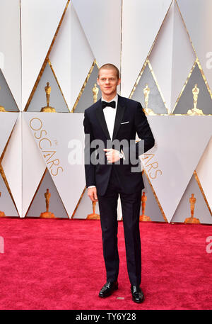 Actor Lucas Hedges arrives with an assortment of Oscar-themed food on ...