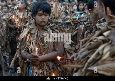 Devotees take part in the ‘Taong Putik’ or mud people festival in the ...