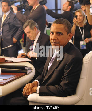U.S. President Barack Obama sits on his desk at the White House Oval ...