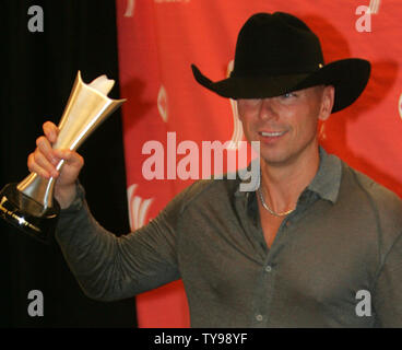 Singer Kenny Chesney wins the Entertainer of the Year trophy at the ...