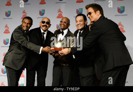 Salsa Giants hold the award they won for Best Salsa Album backstage at ...