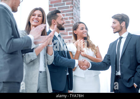 happy business team applauds new business partners.concept of ...