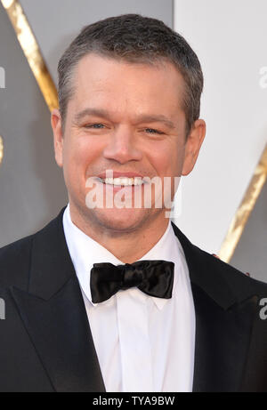 Actor Matt Damon, center, arrives for the screening of Behind the ...