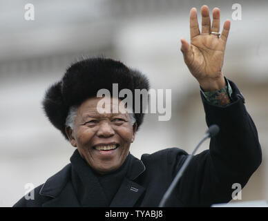 Nelson Mandela waves after delivering a speech for the charity "Make ...