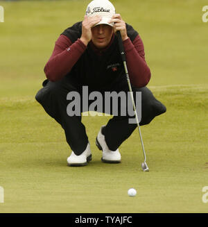 Steve Stricker lines up a putt on the 18th green during the first round ...