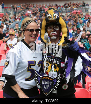 Baltimore Ravens fans pose for a photo while touring the team's locker ...