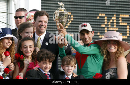 John Velazquez holds the trophy after riding Authentic to victory in ...