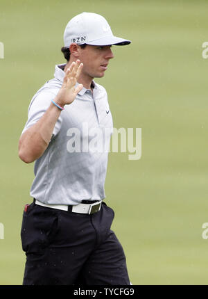 Rory McIlroy, of Northern Ireland, waves after making a putt on the ...
