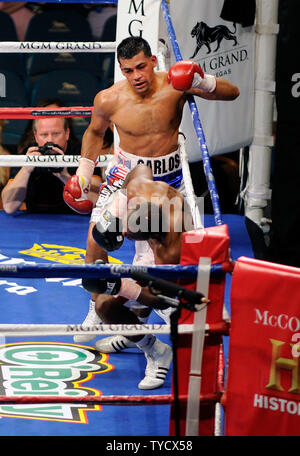 Boxer Carlos Quintana, of Puerto Rico knocks out DeAndre Latimore of Las Vegas, Nev. during the ...