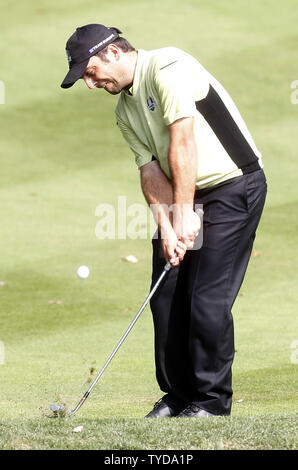 Italy's Francesco Molinari chips in for birdie on the 18th green during ...