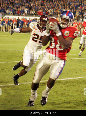 Kansas' Dexton Fields catches a pass in front of Kansas State's Marcus ...