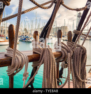 Pin rail with fixed ropes. An old sailing ship Stock Photo - Alamy