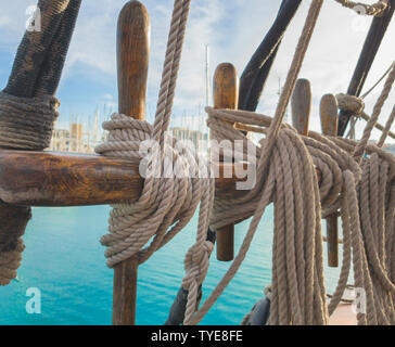 Pin rail with fixed ropes. An old sailing ship Stock Photo - Alamy