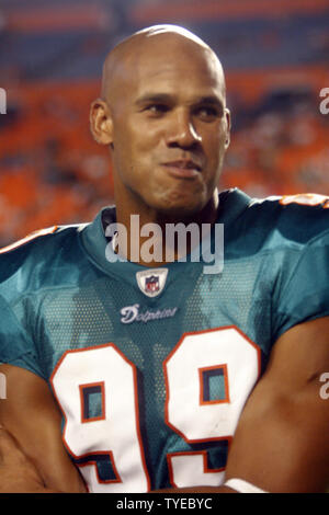 Jason Taylor smiles on the sidelines before the start of an NFL ...