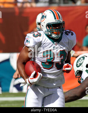 Miami Dolphins runningback Daniel Thomas (33) fights against the ...