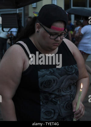 Janice Rivera holds a candle and said a small prayer in downtown ...