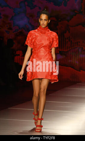 A runway model presents fashions by James Young during Miami Fashion ...