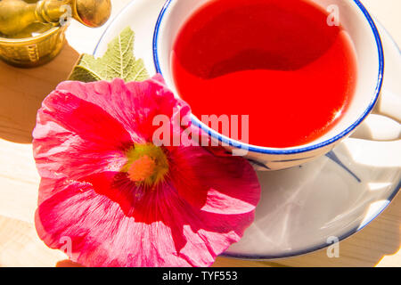 mallow tea, cup with mallow flower and mortar Stock Photo - Alamy