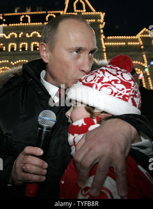 Russian President Vladimir Putin kisses a Alabai puppy gifted him by ...