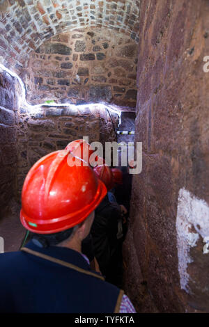 Tour group follow the guide around Exeter's underground passages and ...