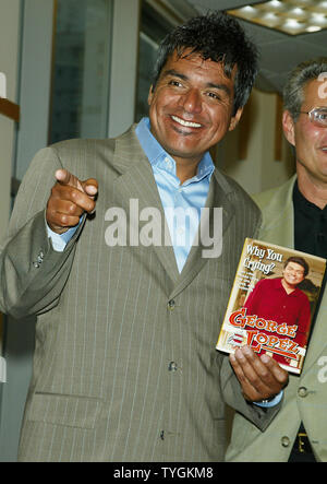 George Lopez poses for pictures before signing copies of his new book ...
