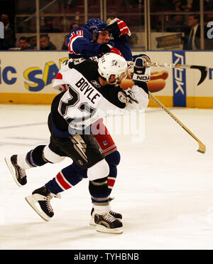 Tampa Bay Lightning's Dan Boyle, right, tries to pull out his stick ...