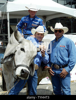 Chris Shivers (on Buck Shot, the bull), Ty Murray and Adriano Moraes ...