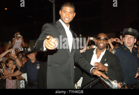 R & B singer Usher greets fans gathered outside the Ambassador theatre ...