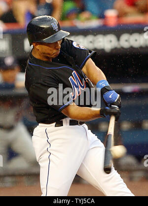 New York Mets' Damion Easley drops his bat as he follows through on a ...