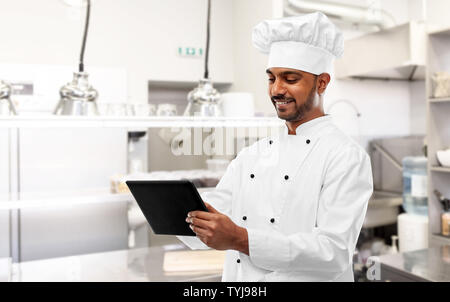 indian chef with tablet pc at restaurant kitchen Stock Photo - Alamy