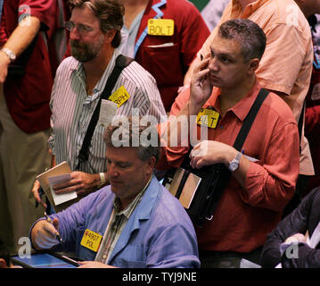 Traders conduct business in the oil options pit at the NYMEX as oil ...