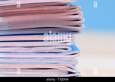 Stack of magazines on blurred background Stock Photo - Alamy
