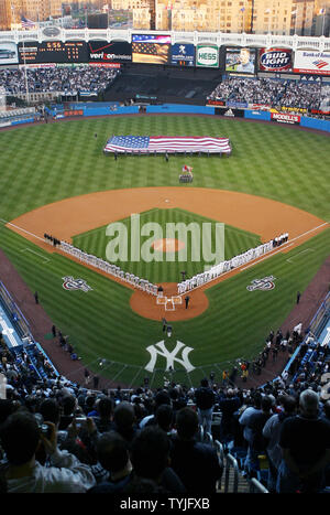 New York Yankees' players stand on the field before a baseball game ...