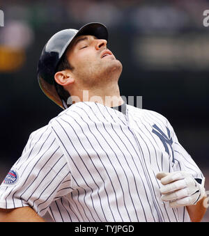 New York Yankees' Xavier Nady heads home after hitting a solo home run ...