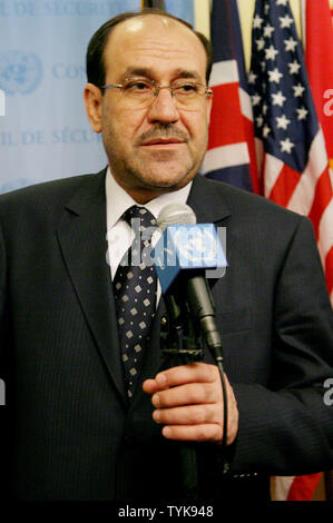 Iraqi's Prime Minister Nouri Kamil al-Maliki (L) talks to the press ...