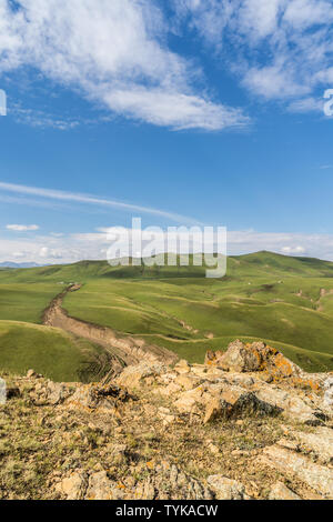Hillside Prairie Road under blue sky and white clouds Stock Photo - Alamy